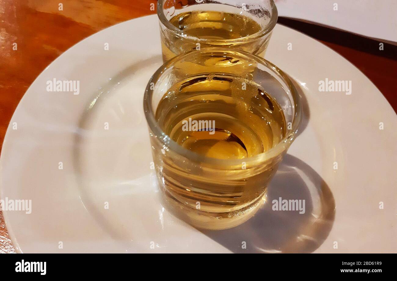 two nice glasses of hierba digestive liqueur typical of ibiza in spain ...