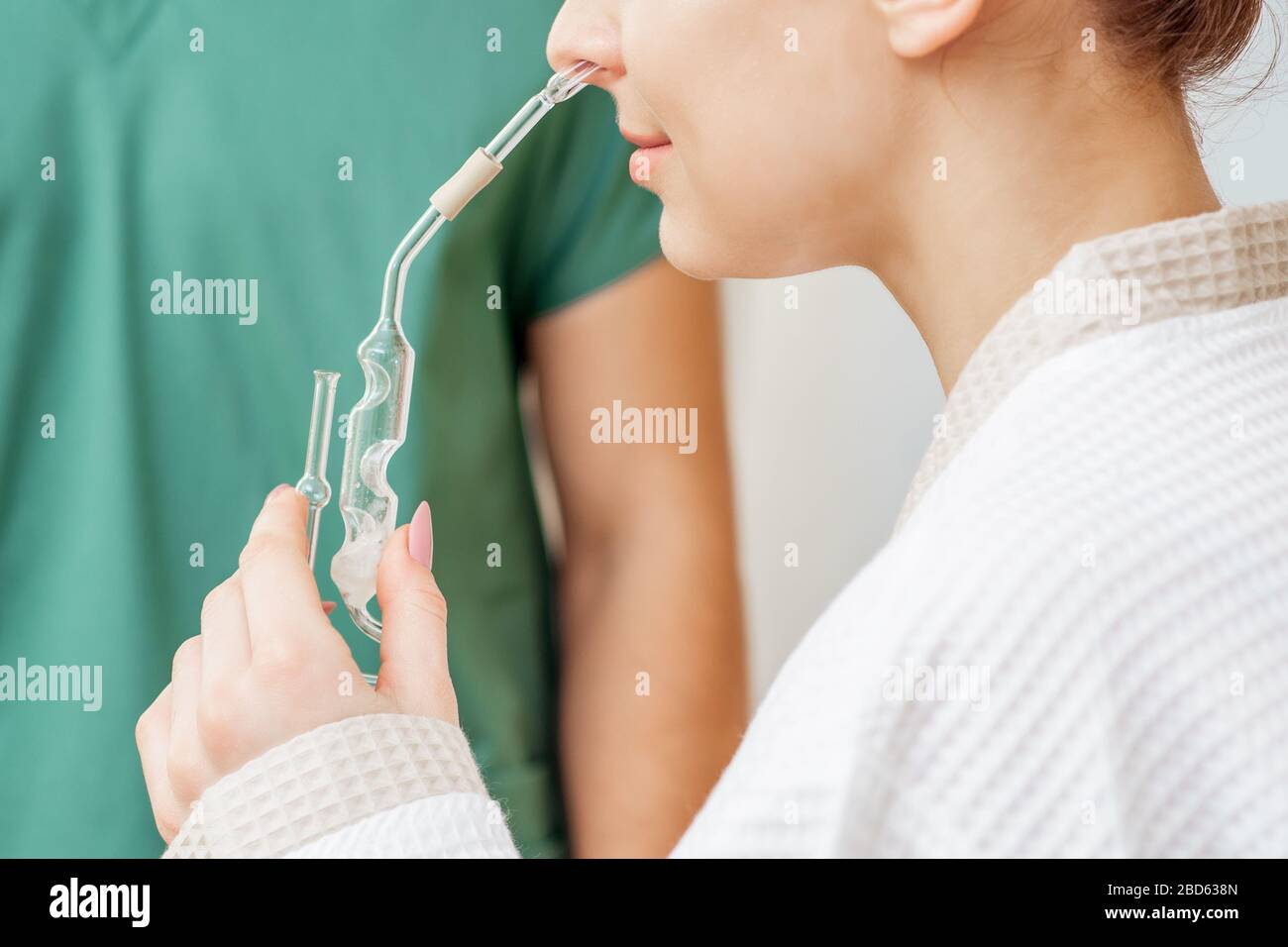 Woman receives nasal inhalation Maholda by essential oil in nose at spa ...