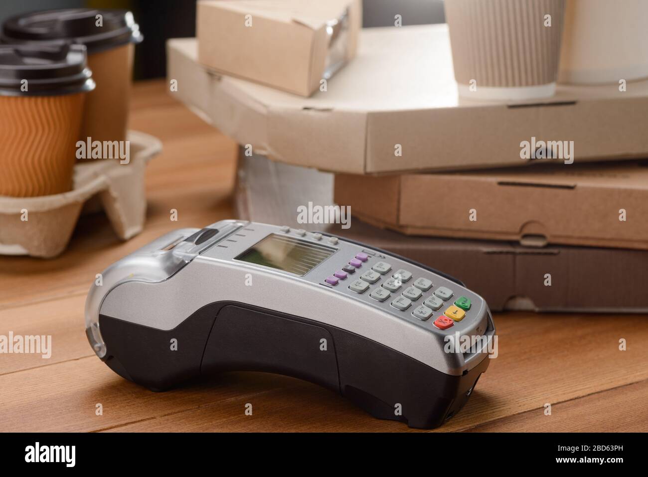 Credit card reader, cups of coffee and pizza boxes Stock Photo - Alamy