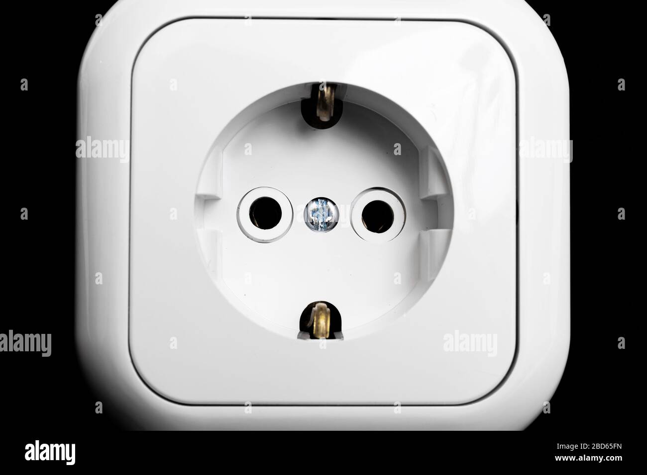 White electrical socket on black background closeup Stock Photo - Alamy