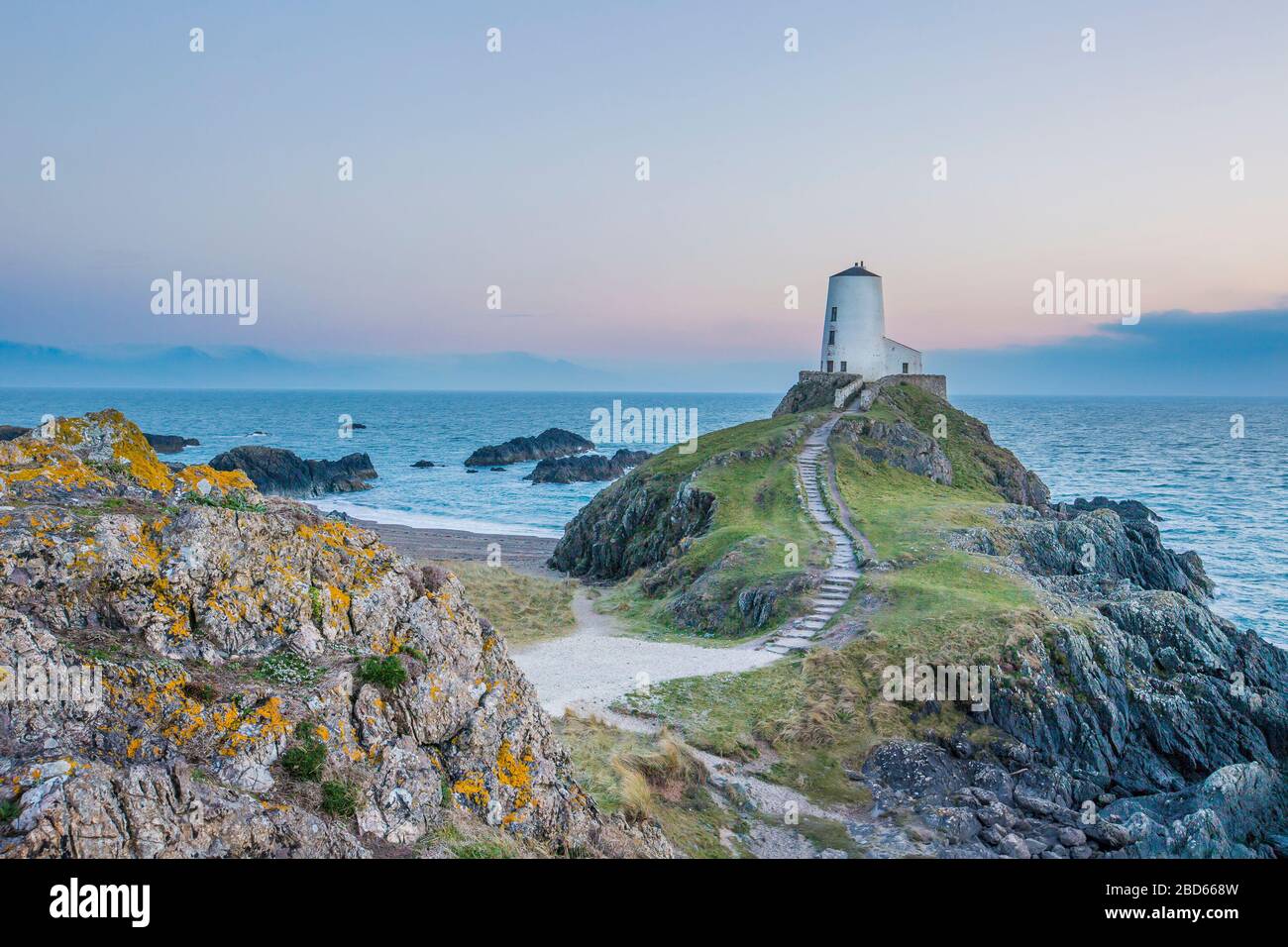 Early evening sunset, Twr Mawr lighthouse on tidal island of Llanddwyn ...