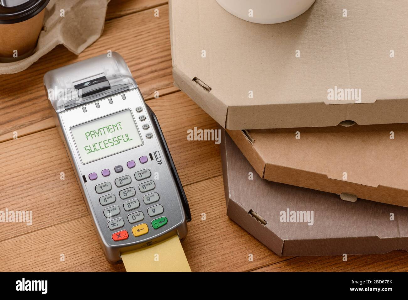 Payment terminal with inserted card and pizza boxes Stock Photo - Alamy