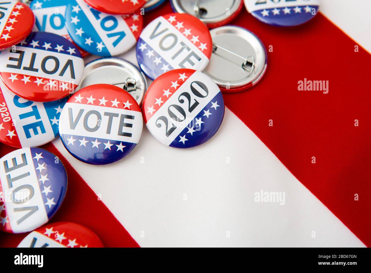 American vote badges on national USA flag background Stock Photo - Alamy