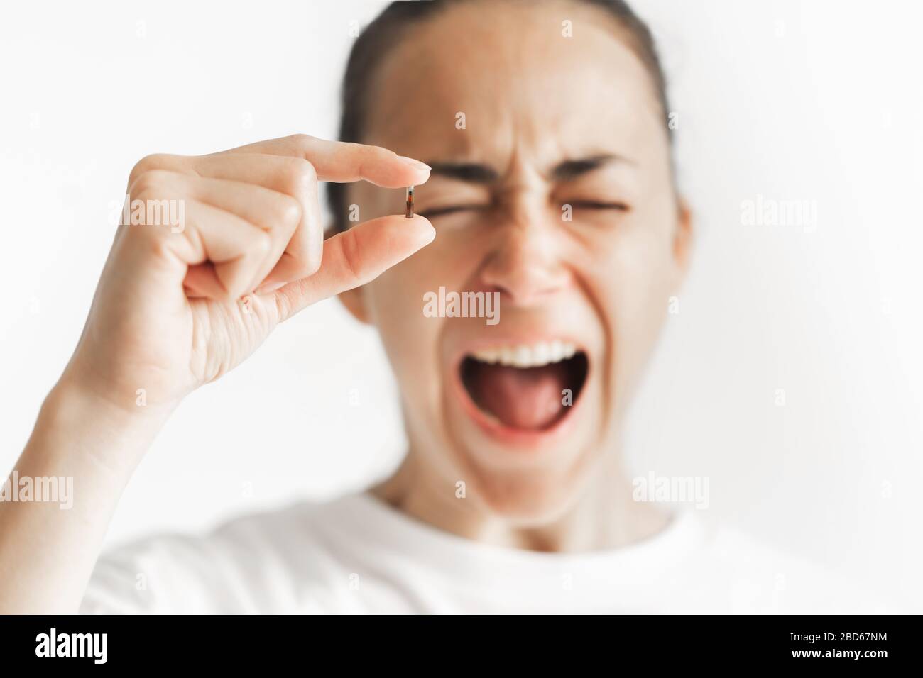 Person holding in fingers micro chip for implantation with defocused ...