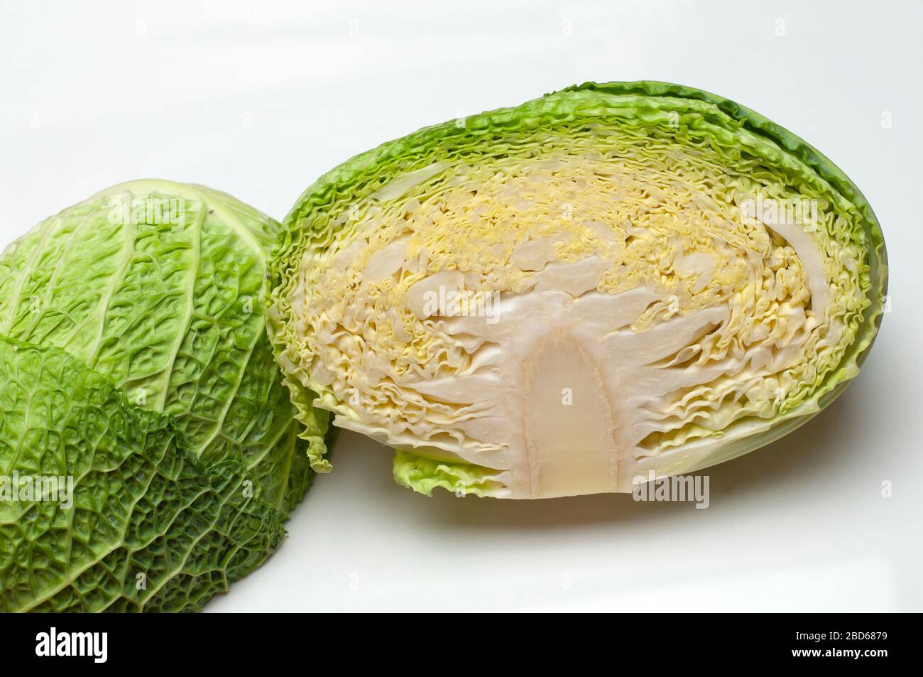 close-up of a halved head of a savoy cabbage isolated on white ...