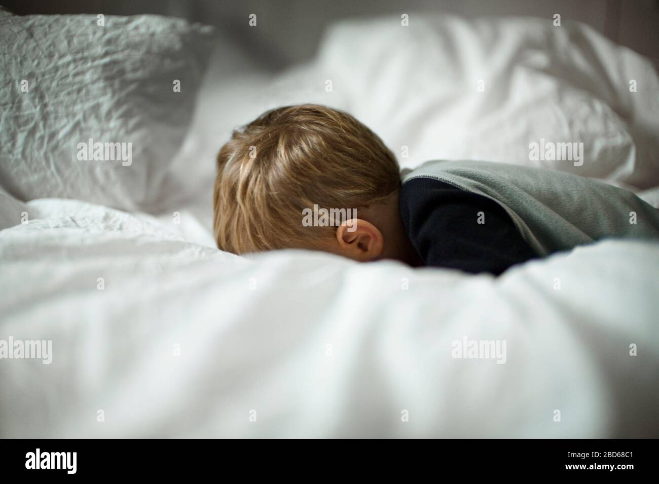 A young boy napping in bed Stock Photo - Alamy