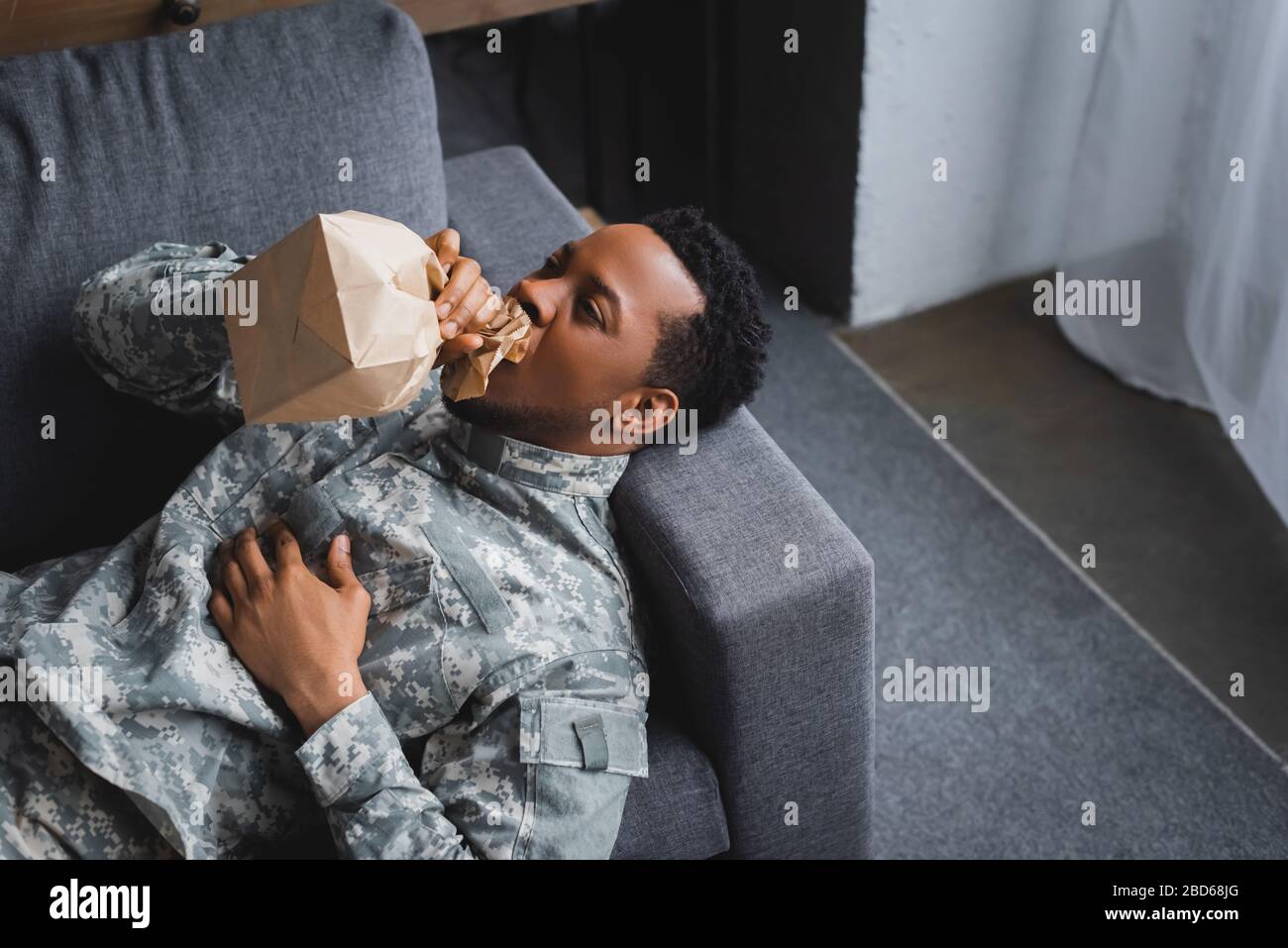 stressed african american soldier in military uniform breathing with ...