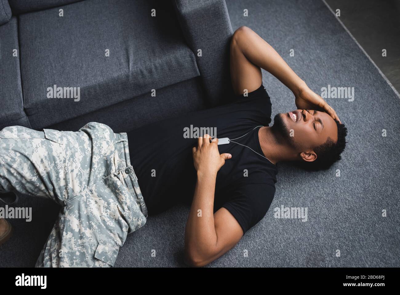 stressed african american soldier with army badge having heart attack ...