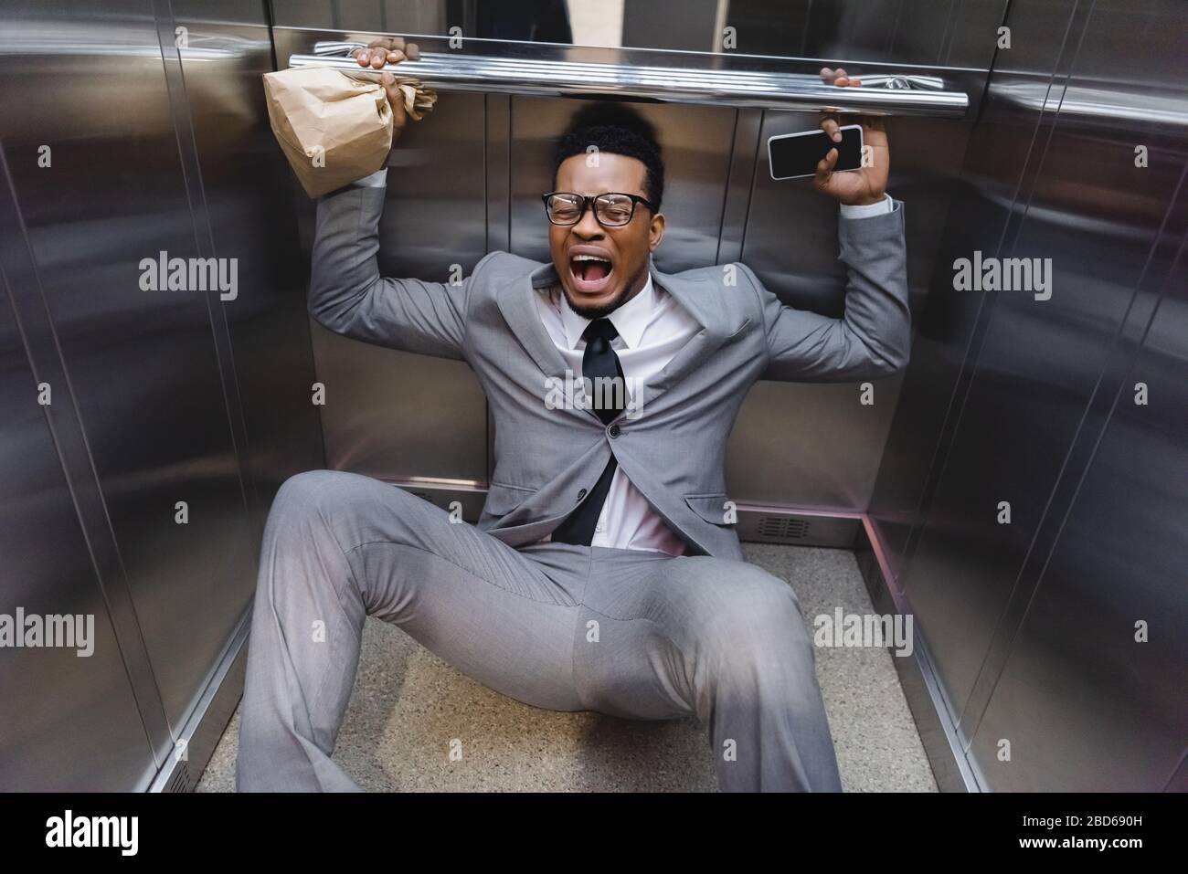 scared screaming african american businessman with smartphone and paper ...