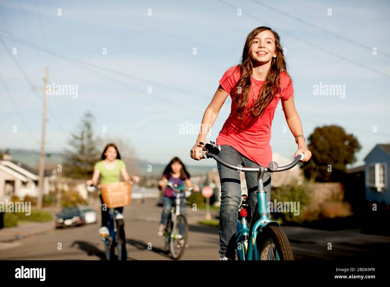 Group of teenage girls cycling along the street together Stock Photo ...