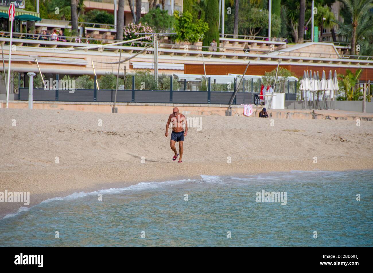 Man walking the beach in November, Monaco Stock Photo - Alamy