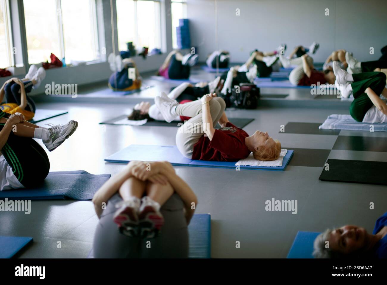 Elderly exercise class stretches on mat Stock Photo - Alamy