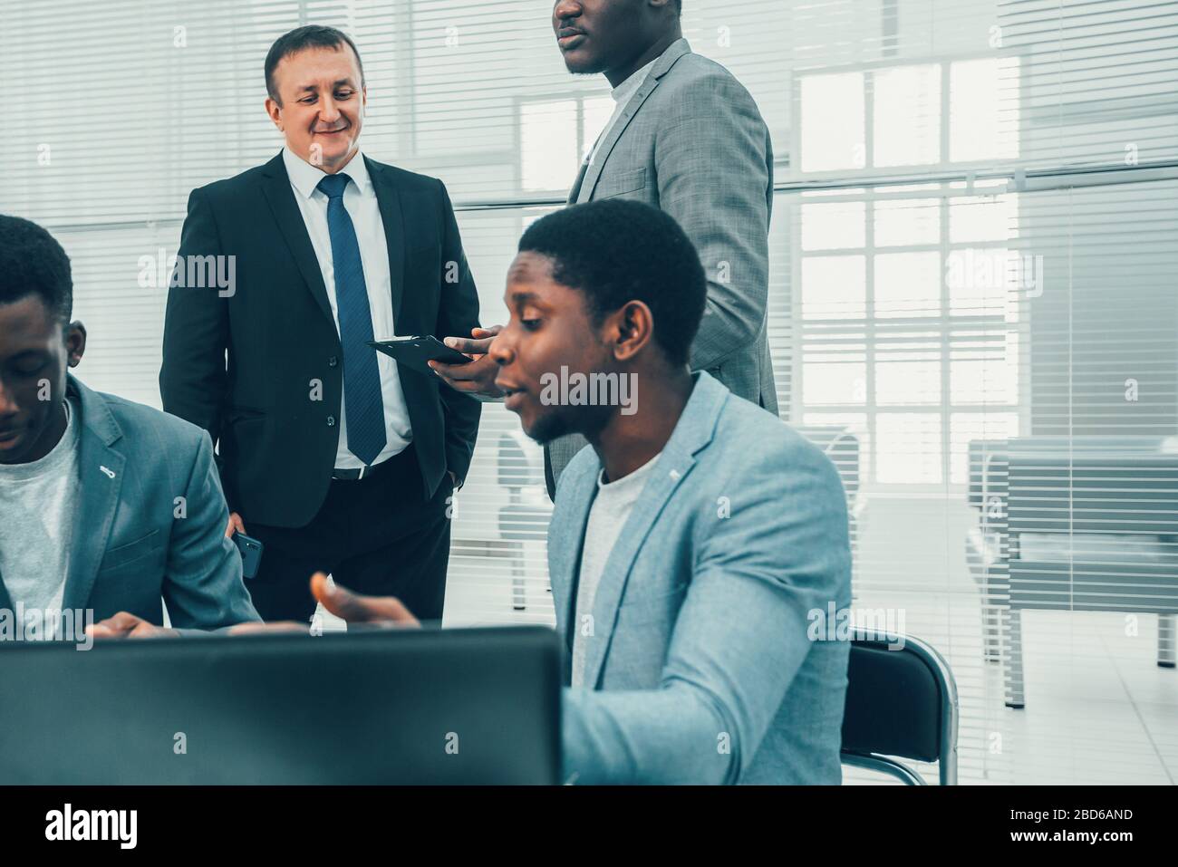 multinational business team works in the office Stock Photo - Alamy