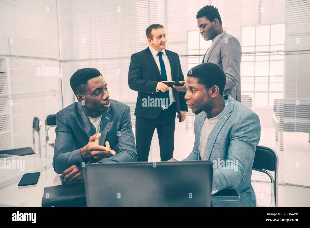 multinational business team works in the office Stock Photo - Alamy