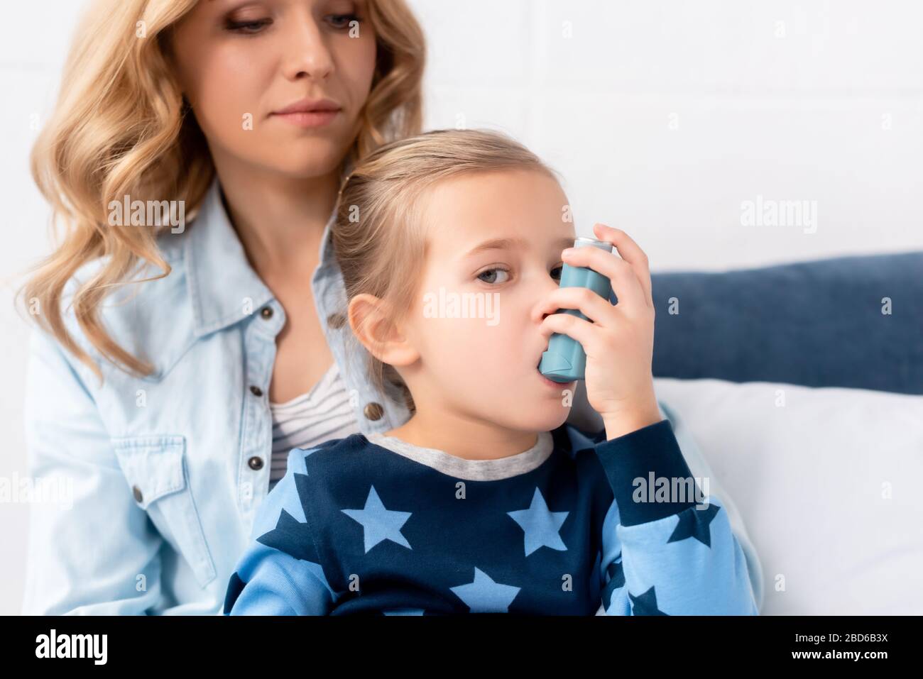 caring mother looking at sick daughter using inhaler Stock Photo - Alamy