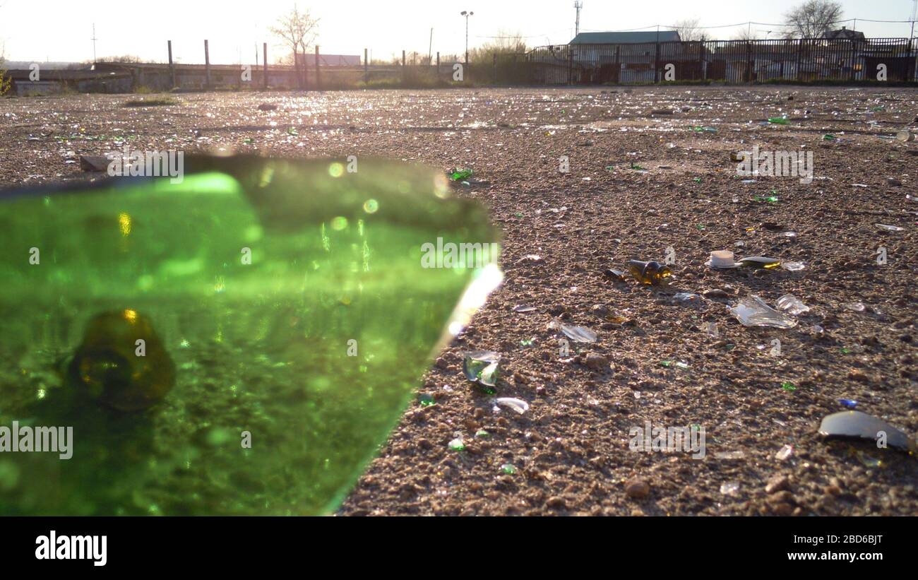 Broken glass bottles of beer and alcohol on the sidewalk. Urban ...