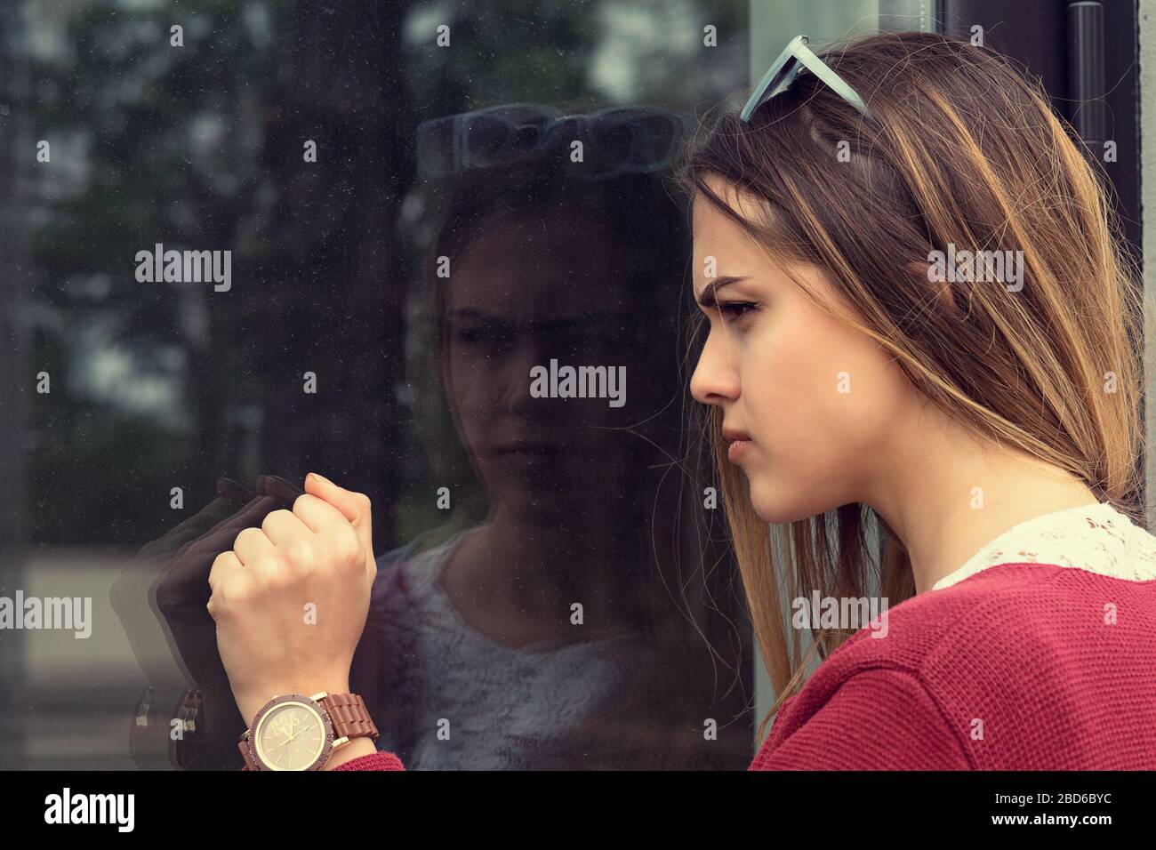 Closeup portrait unhappy young business woman, head on window, bothered ...