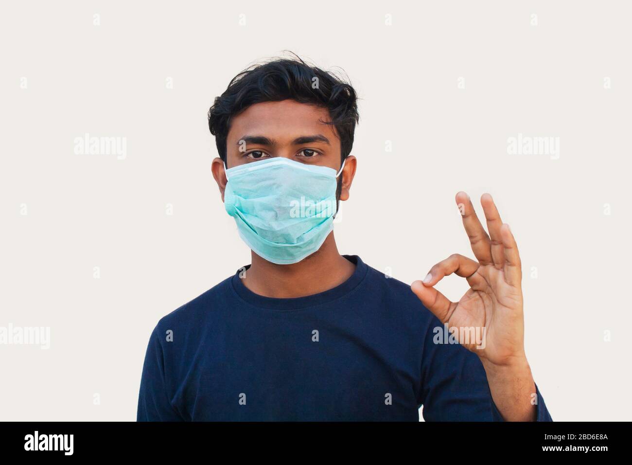 Young boy Wearing Protective Mask and Showing OK sign Stock Photo - Alamy
