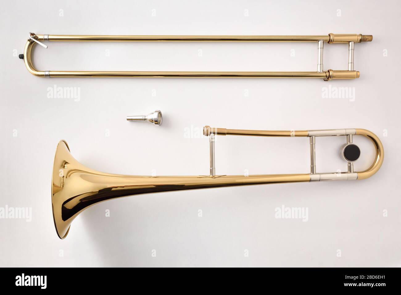 Trombone disassembled on white table. Top view. Horizontal composition ...