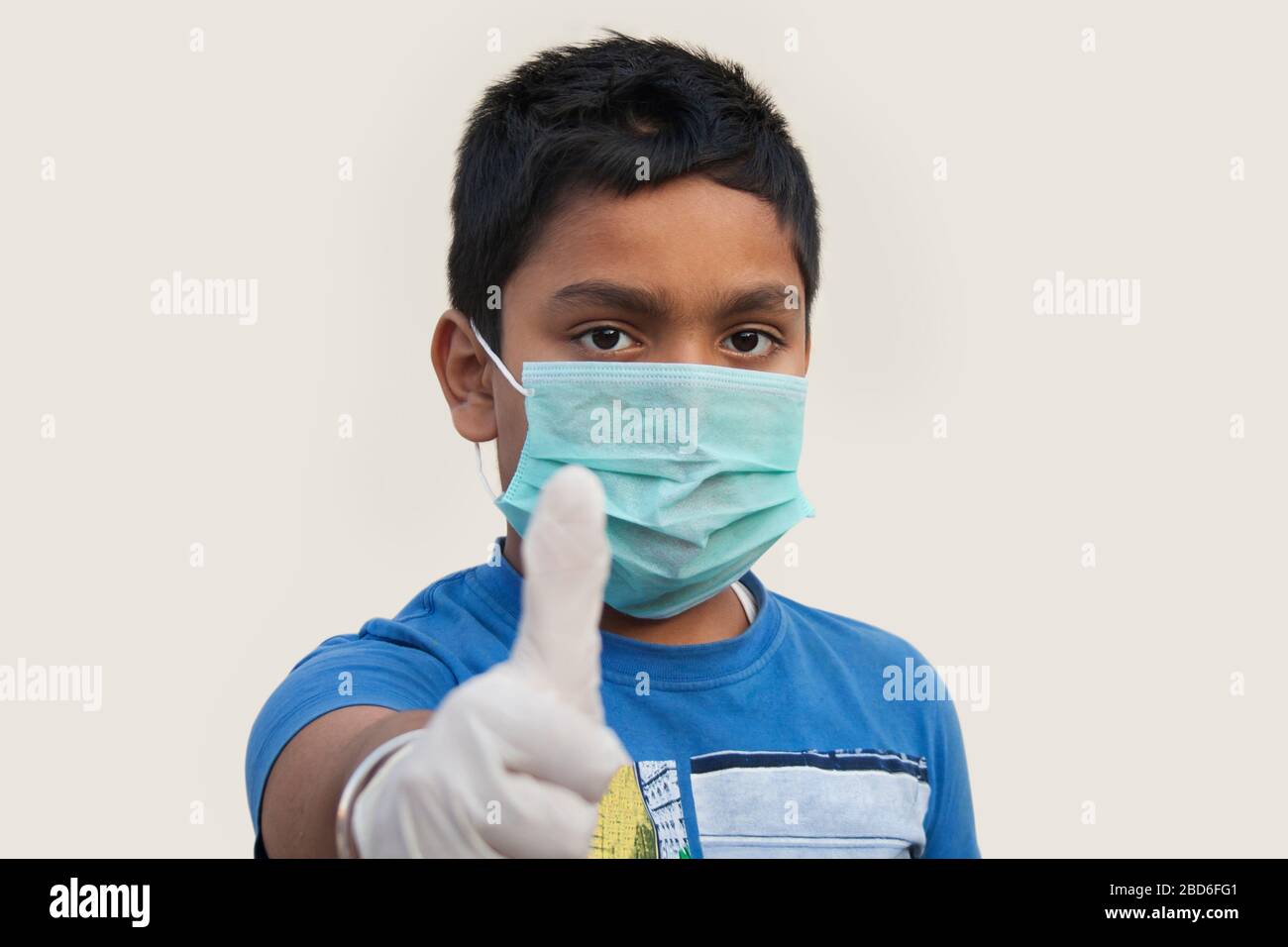 Boy wearing rubber glove And protective mask Pointing Stock Photo - Alamy