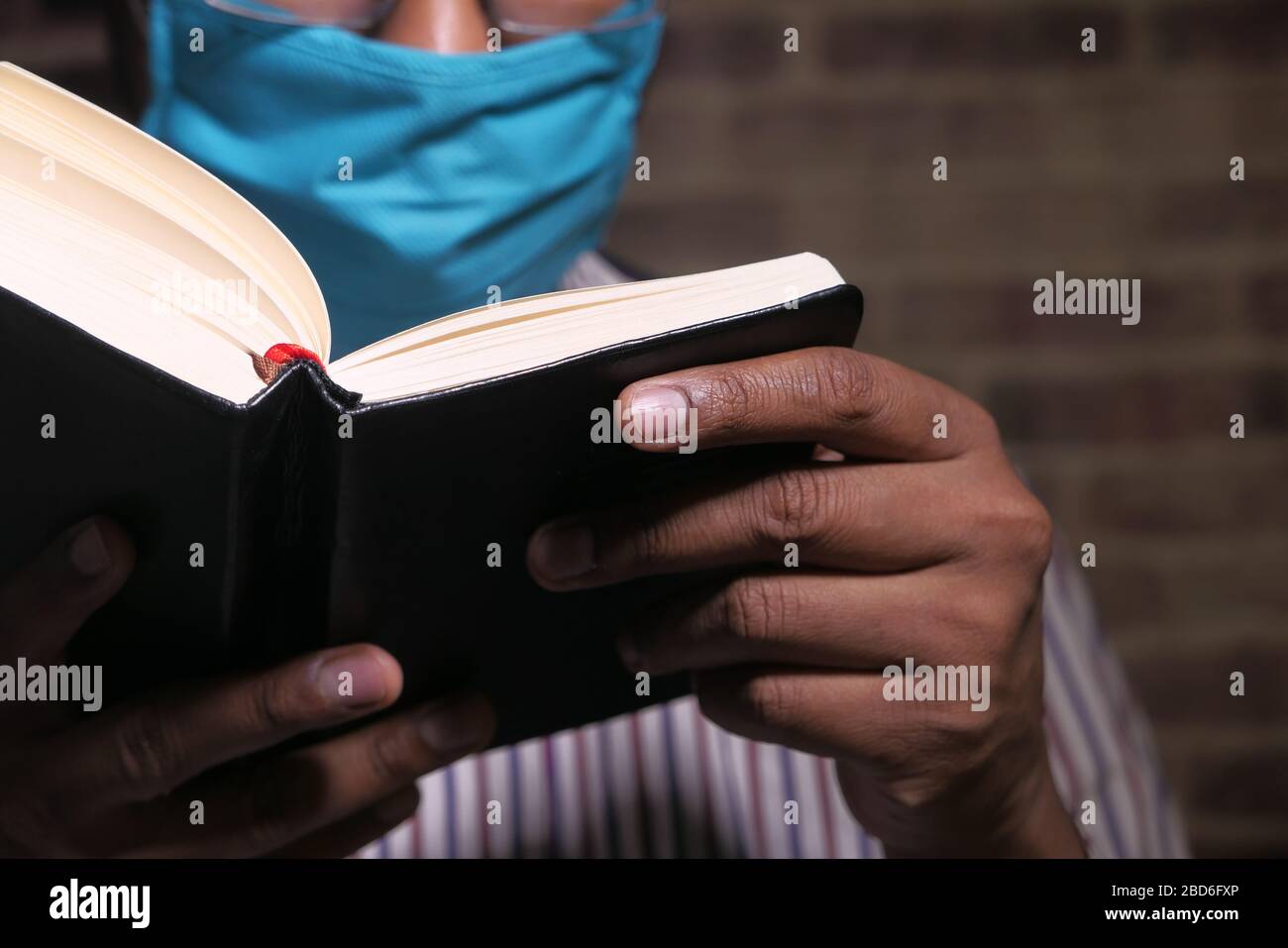 Man with prevent the infectious reading book , social distance concept ...