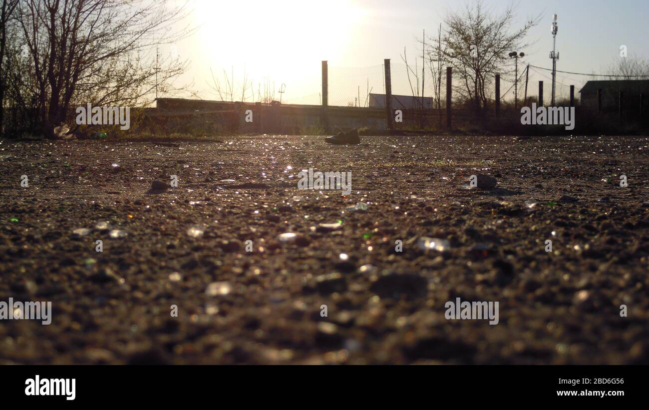 An old boot in the midst of urban trash, lie on the pavement under the ...