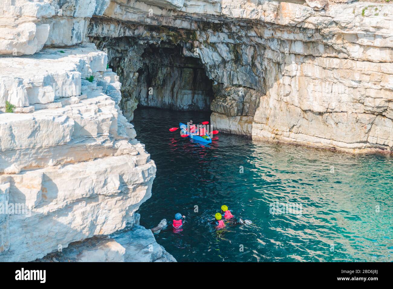people swimming to grotto cave in sea famous landmark Stock Photo - Alamy