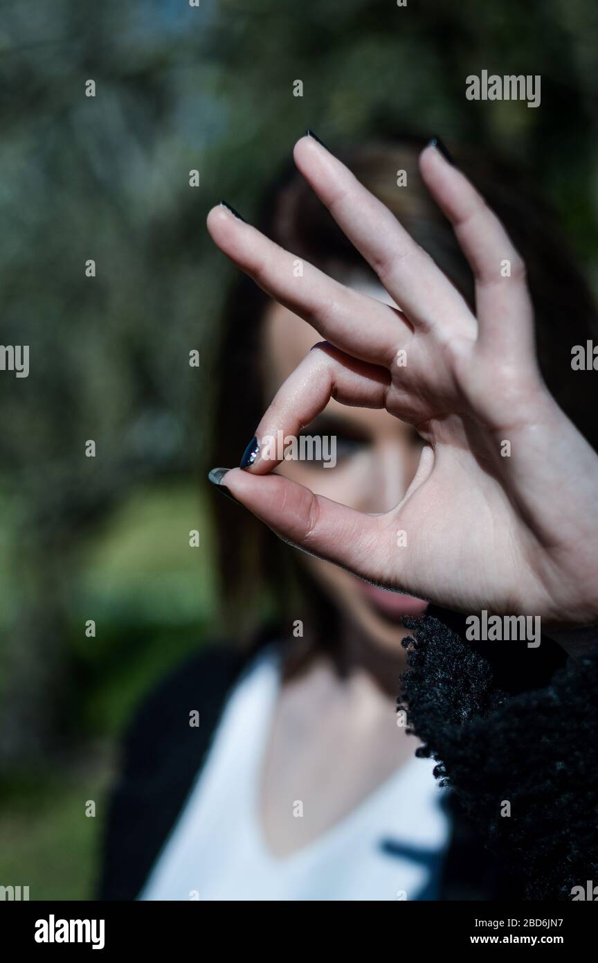 Young woman making ok sign with the hand. Happy girl giving satisfied ...