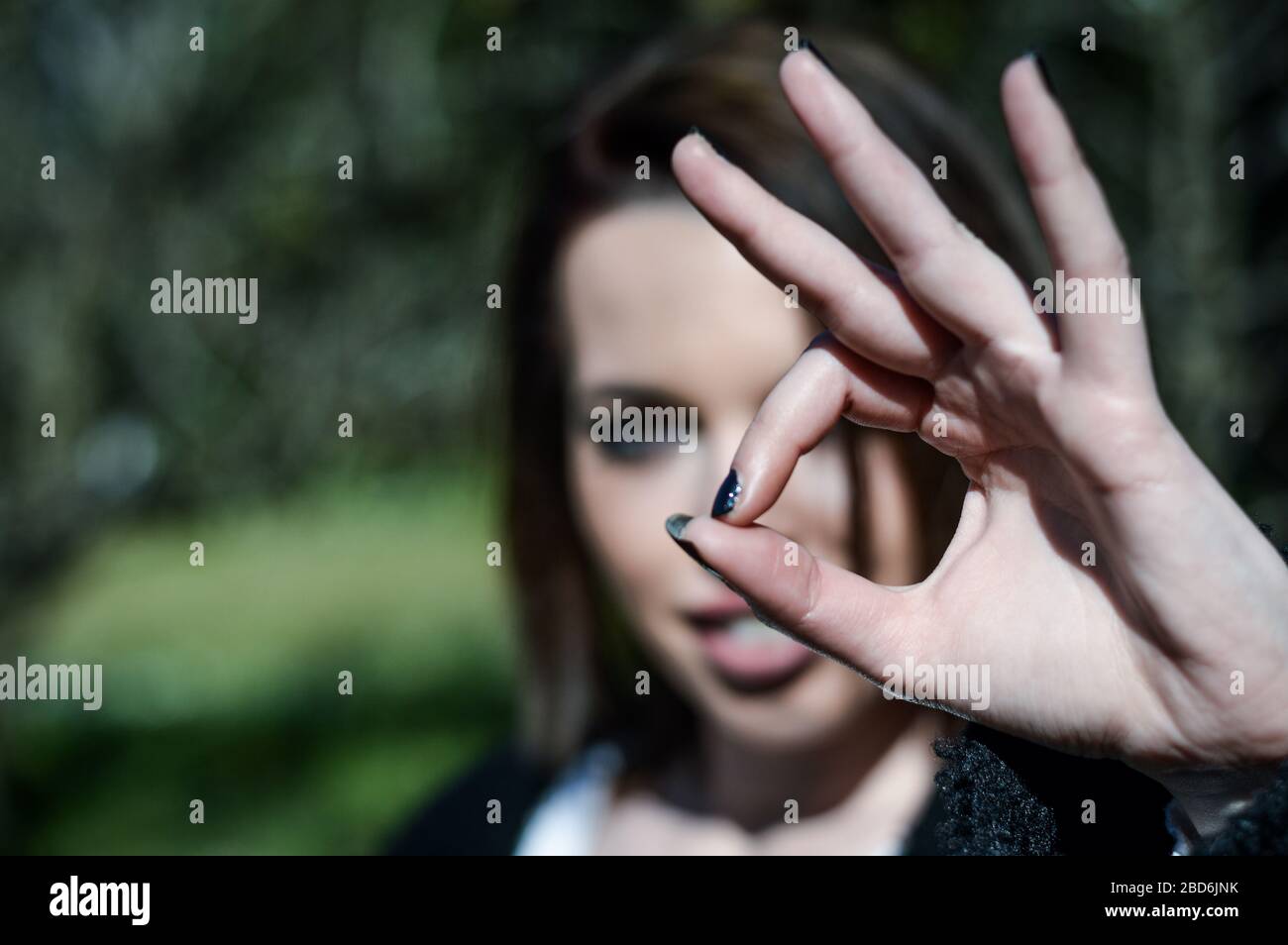 Young woman making ok sign with the hand. Happy girl giving satisfied ...