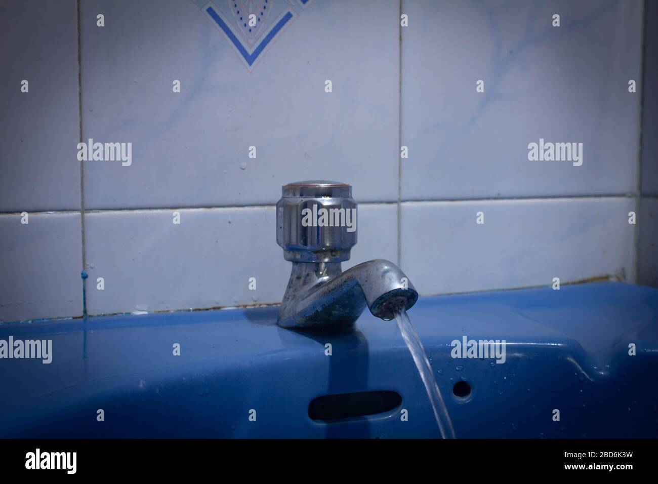 An open tap with water flowing in wash basin Stock Photo - Alamy