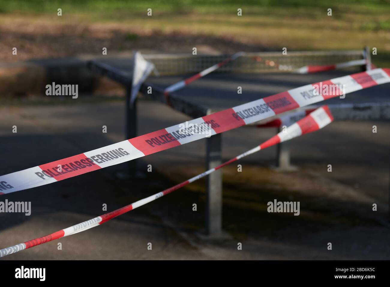 A police cordon hanging from a ping-pong table in a recreation park ...