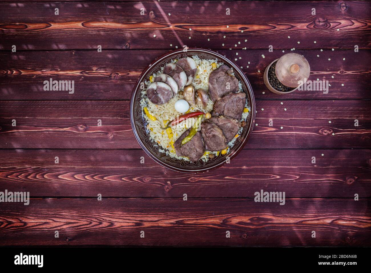 The concept of oriental cuisine. National Uzbek pilaf with meat. Top ...