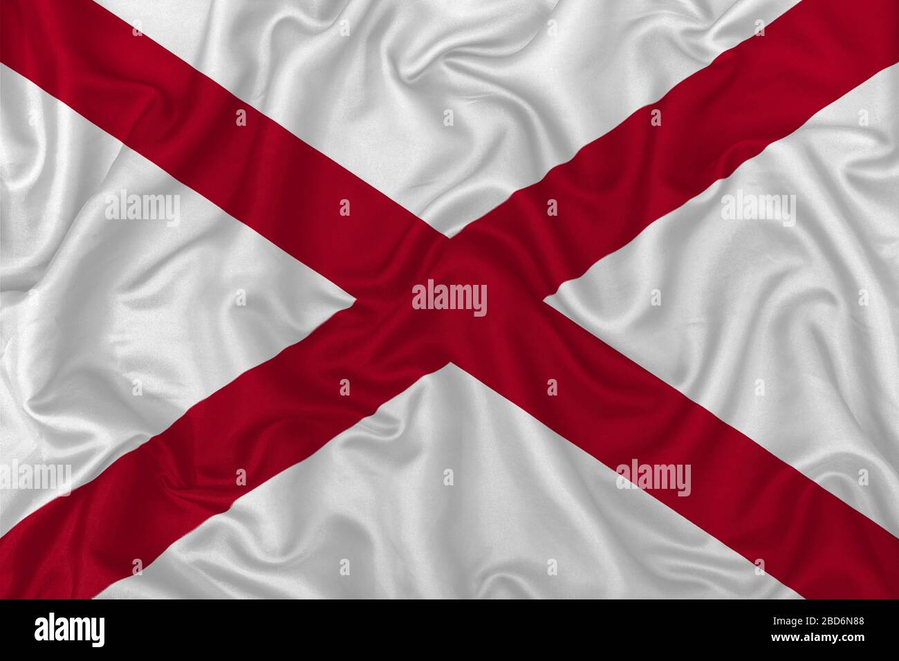Alabama state flag on a wavy silk satin fabric texture background Stock ...