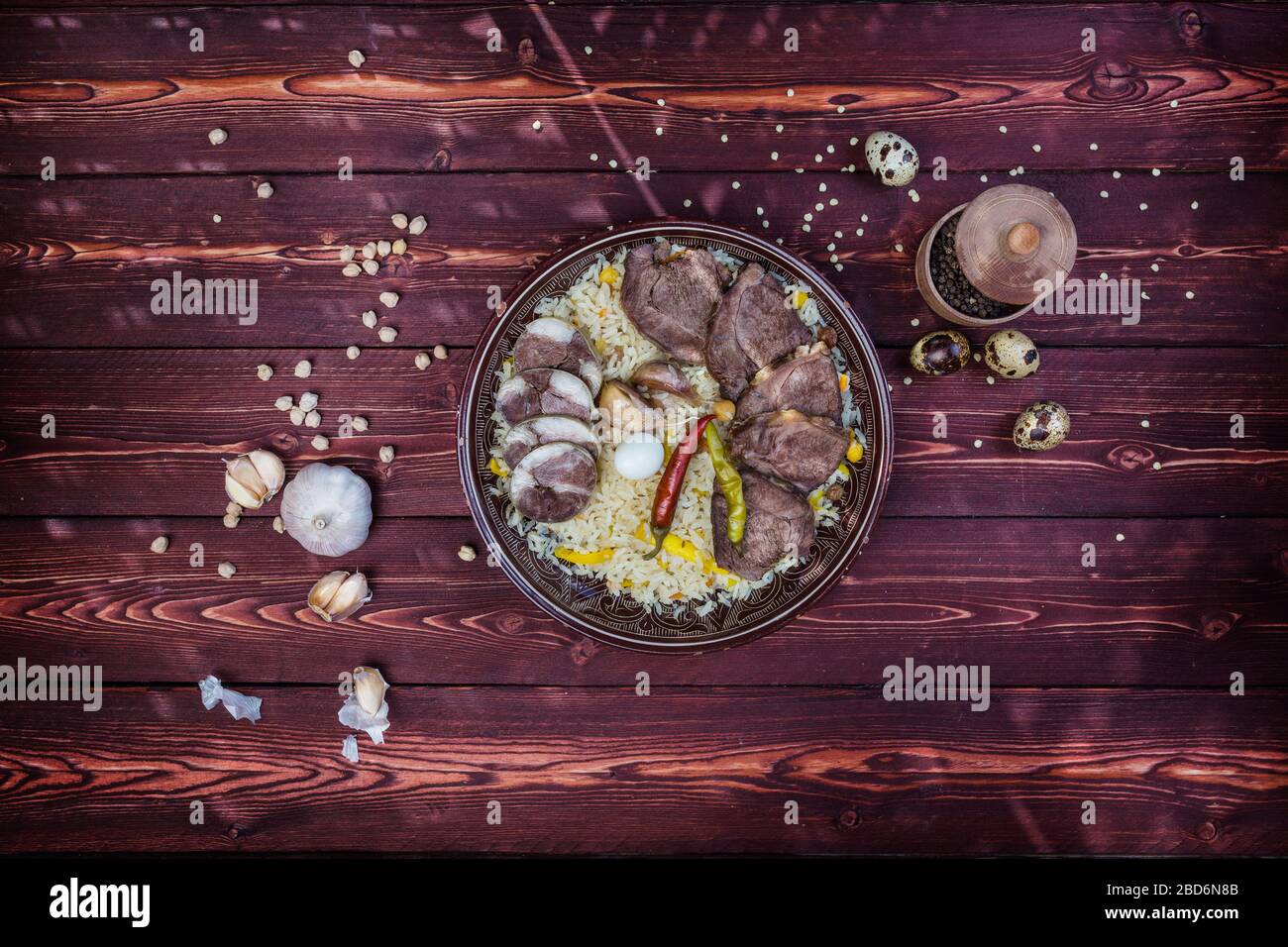 The concept of oriental cuisine. National Uzbek pilaf with meat. Top ...