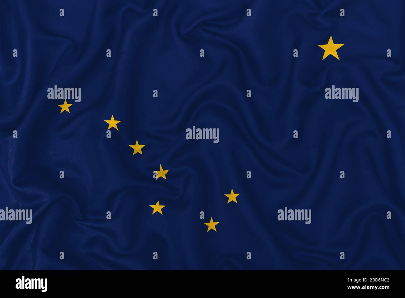 Alaska state flag on a wavy silk satin fabric texture background Stock ...