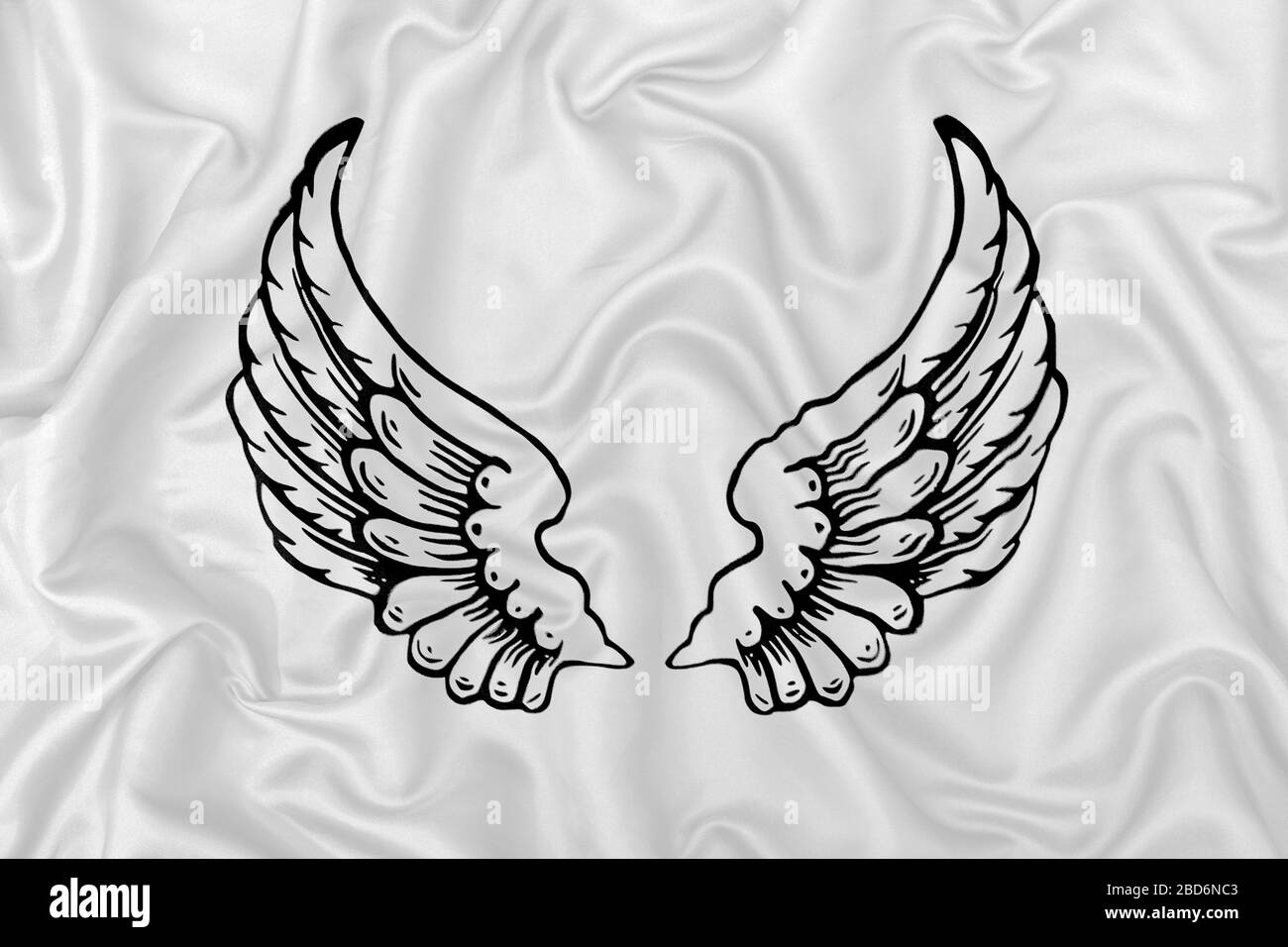 Close view of white fabric with white angel wings Stock Photo - Alamy