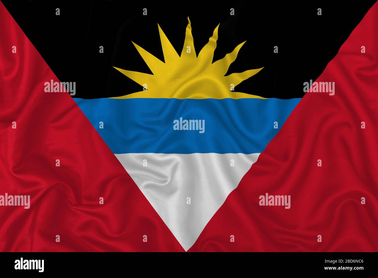 Antigua and Barbuda country flag on wavy silk textile fabric background ...