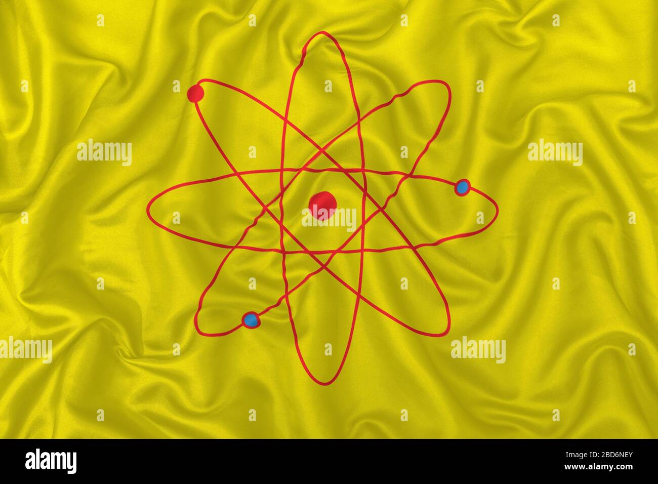 Atom sign symbol isolated in a yellow silk satin fabric texture Stock ...