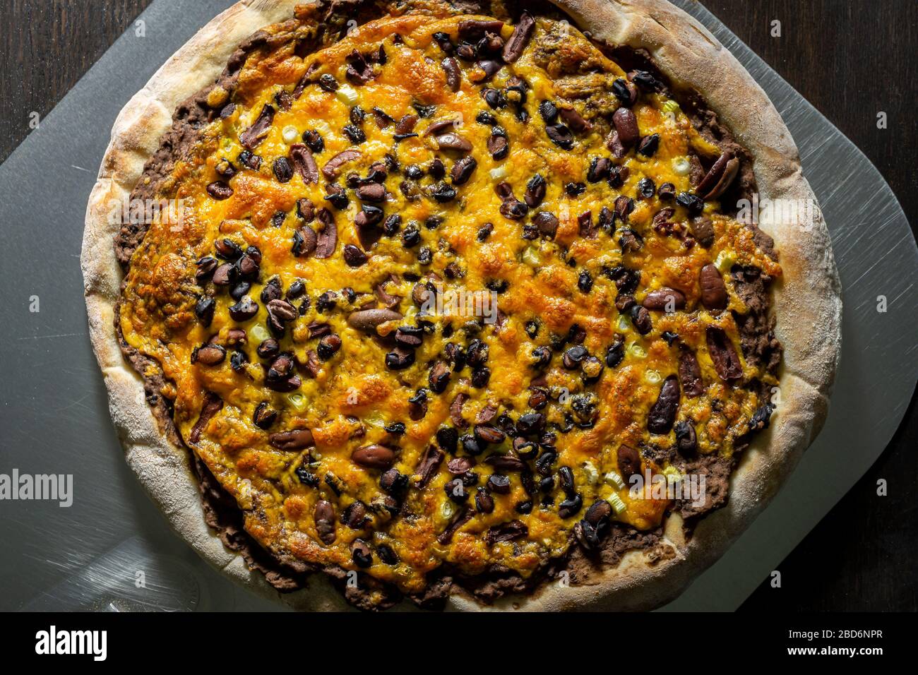 Taco pizza bottom layer. Cooked on pizza peel Stock Photo - Alamy