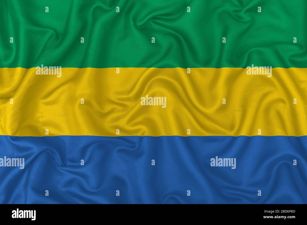 Gabon country flag on wavy silk textile fabric background Stock Photo ...