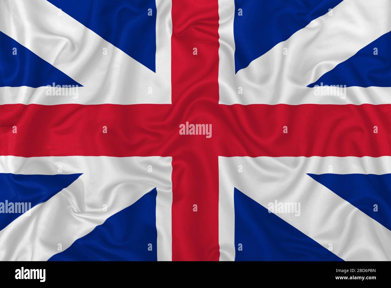 Great Britain historical flag on wavy silk textile fabric background ...