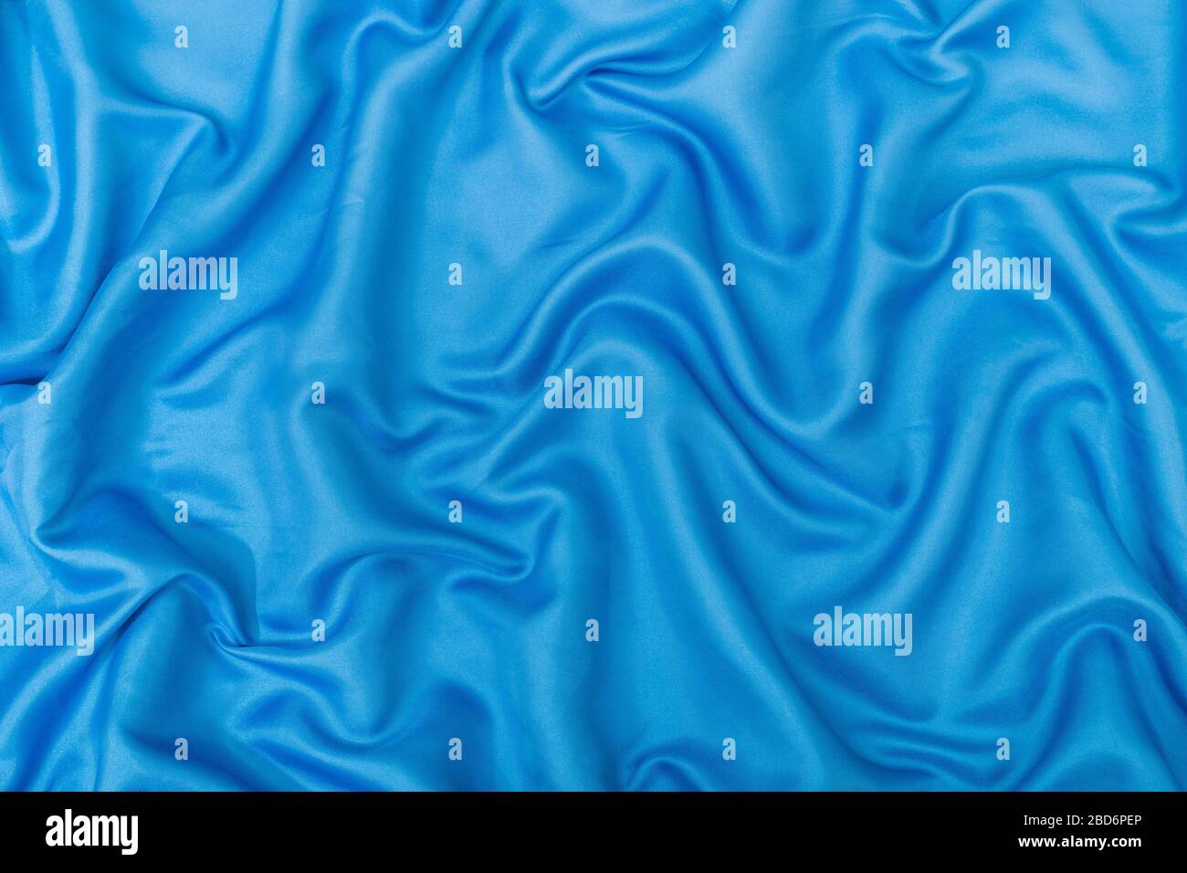 Wavy blue color silk fabric texture background Stock Photo - Alamy