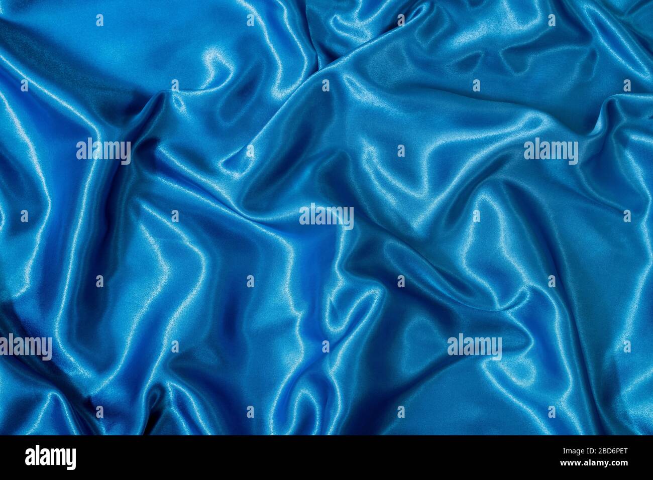 Wavy blue color silk fabric texture background Stock Photo - Alamy