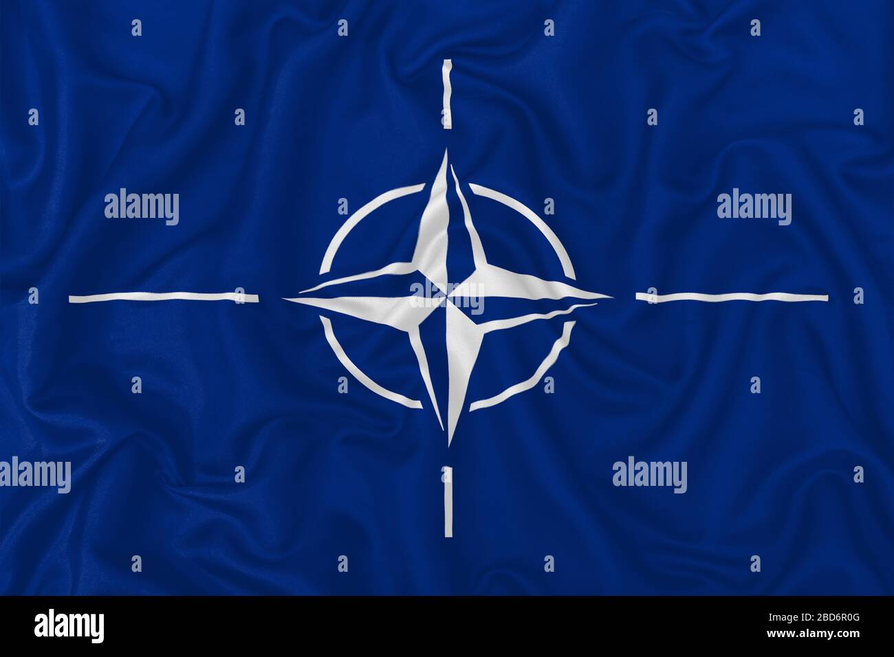 North Atlantic Treaty Organization (NATO) flag on wavy silk textile ...