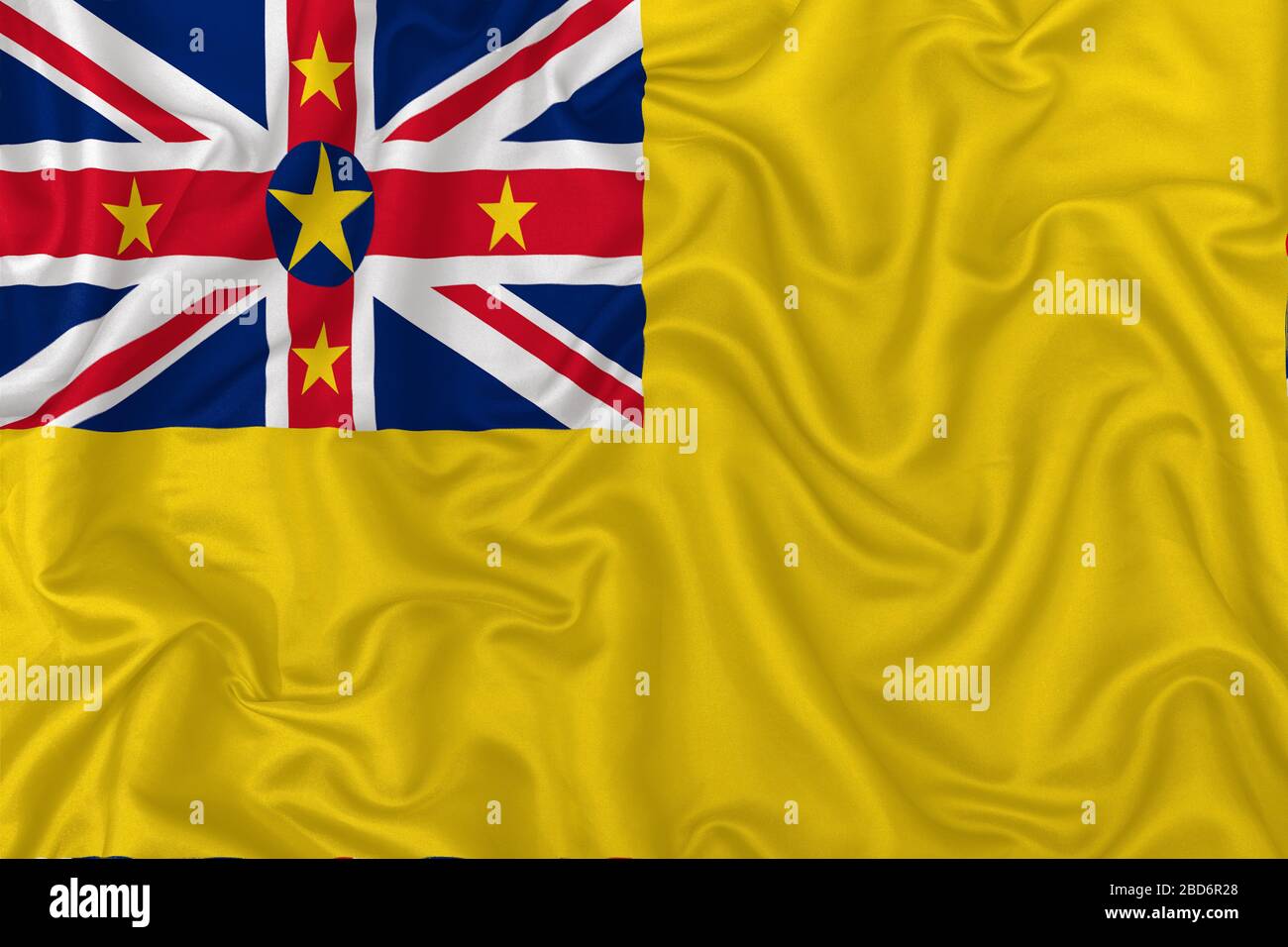 Niue country flag on wavy silk textile fabric background Stock Photo ...