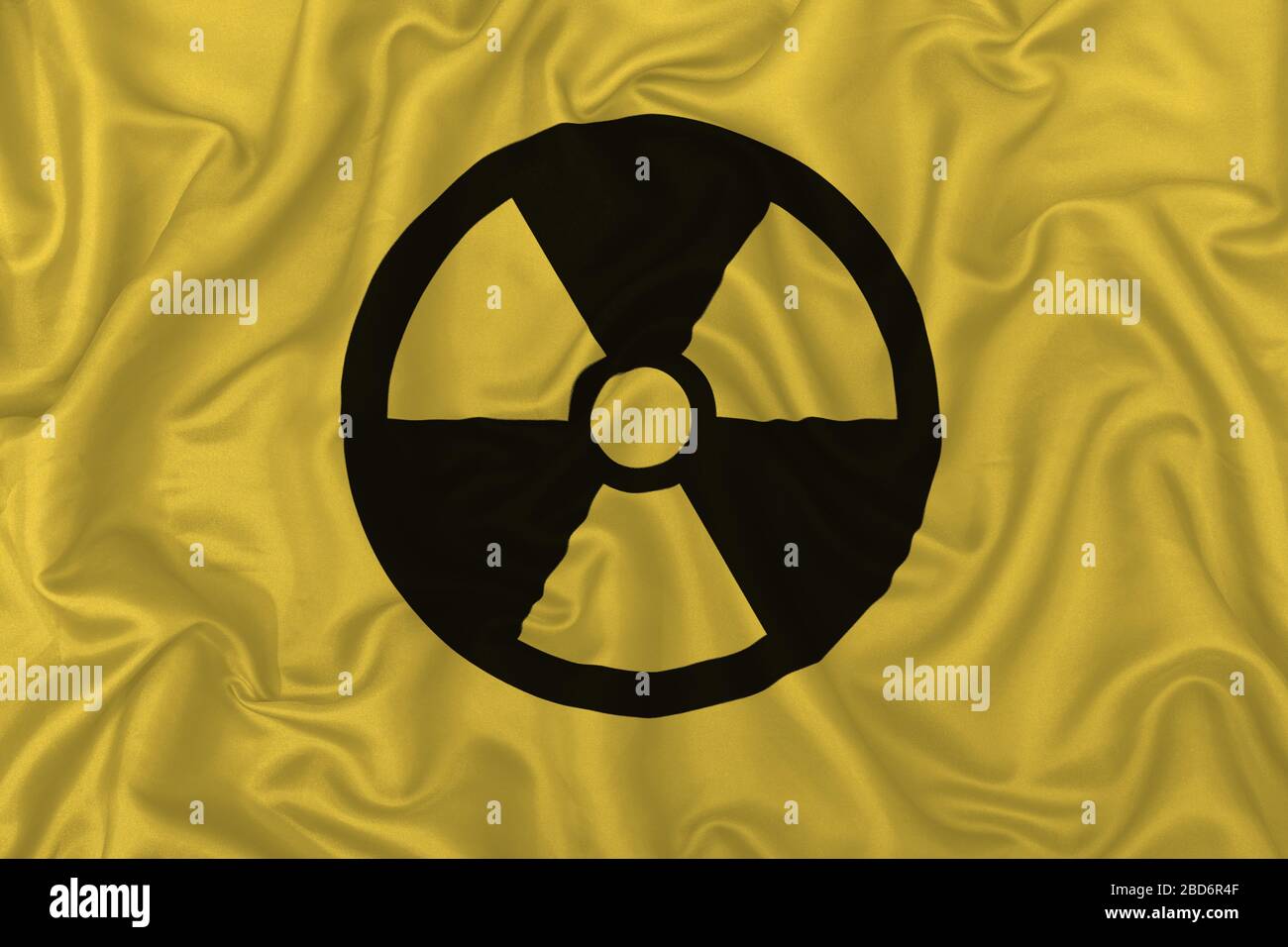 View of the Nuclear symbol on yellow silk satin fabric texture ...