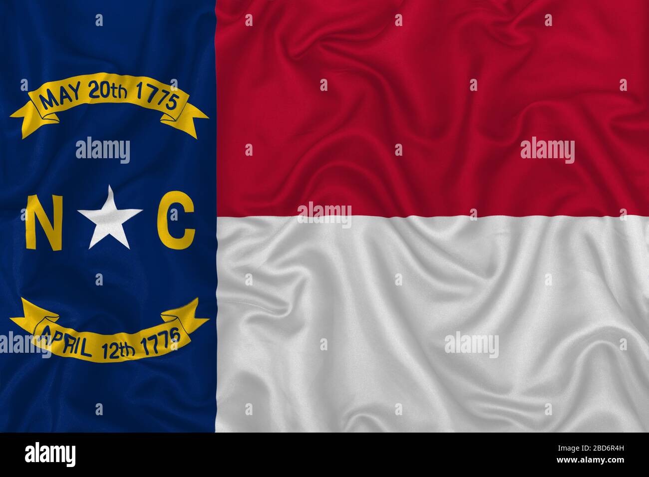 North Carolina state flag on a wavy silk satin fabric texture ...