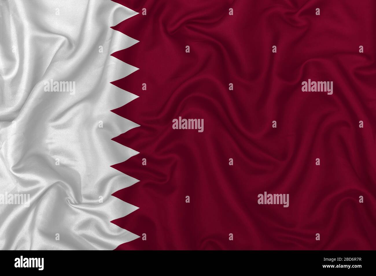 Qatar country flag on wavy silk textile fabric background Stock Photo ...