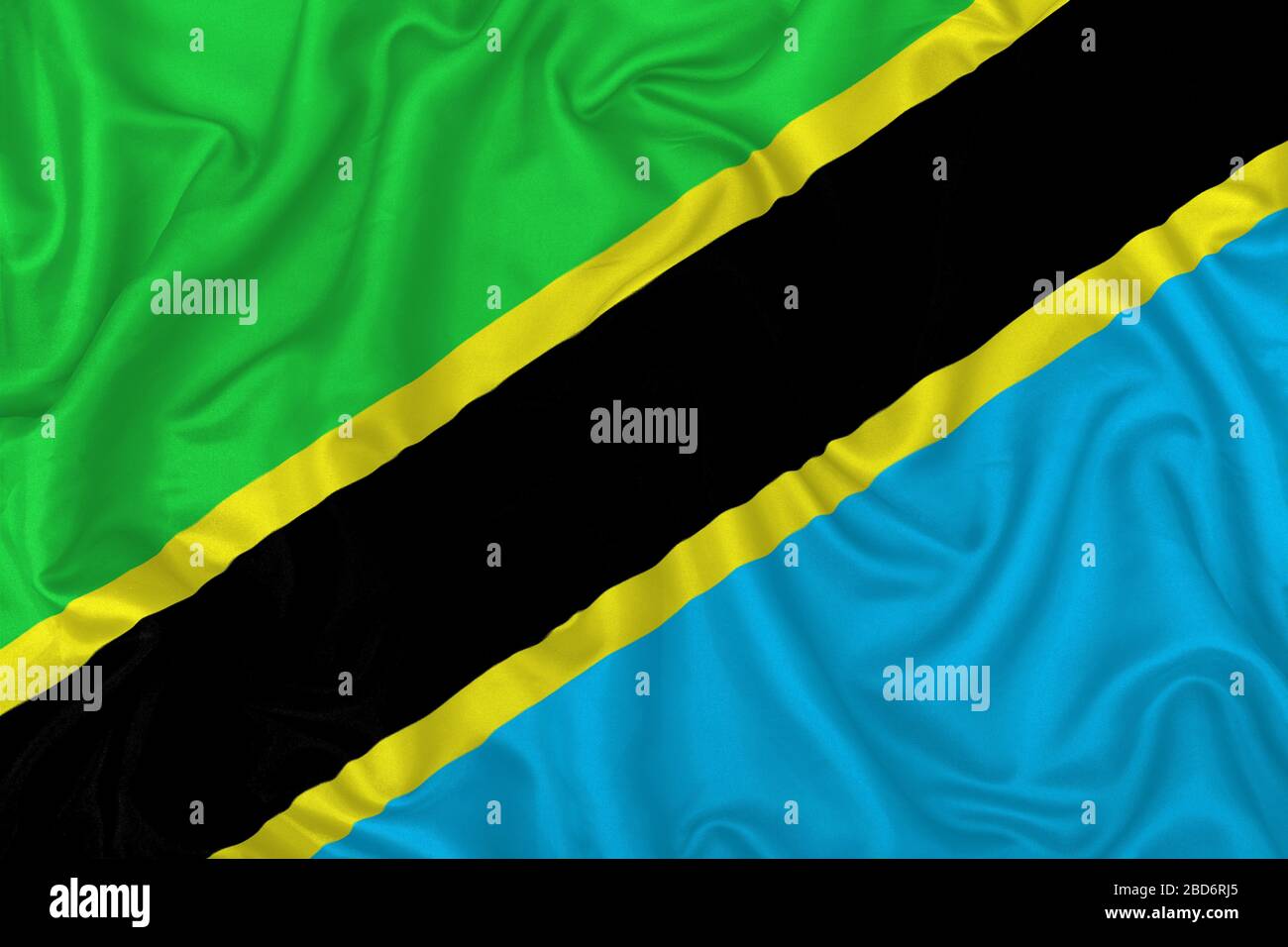 Tanzania country flag on wavy silk textile fabric background Stock ...