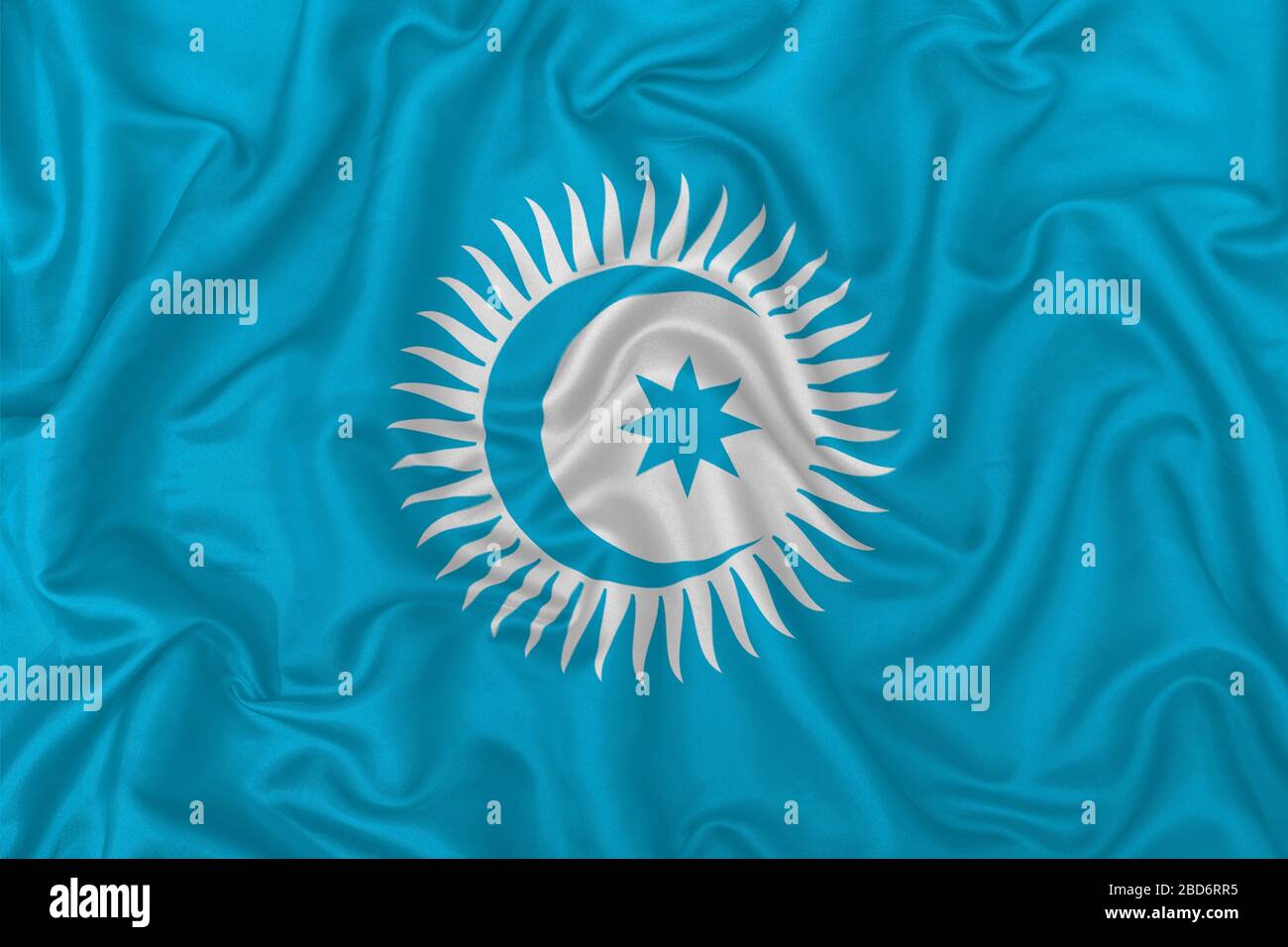 Turkic Council flag on wavy silk textile fabric background Stock Photo ...